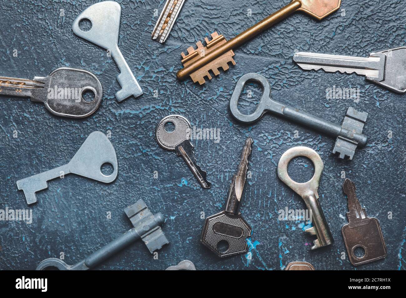 Many keys on dark background Stock Photo - Alamy