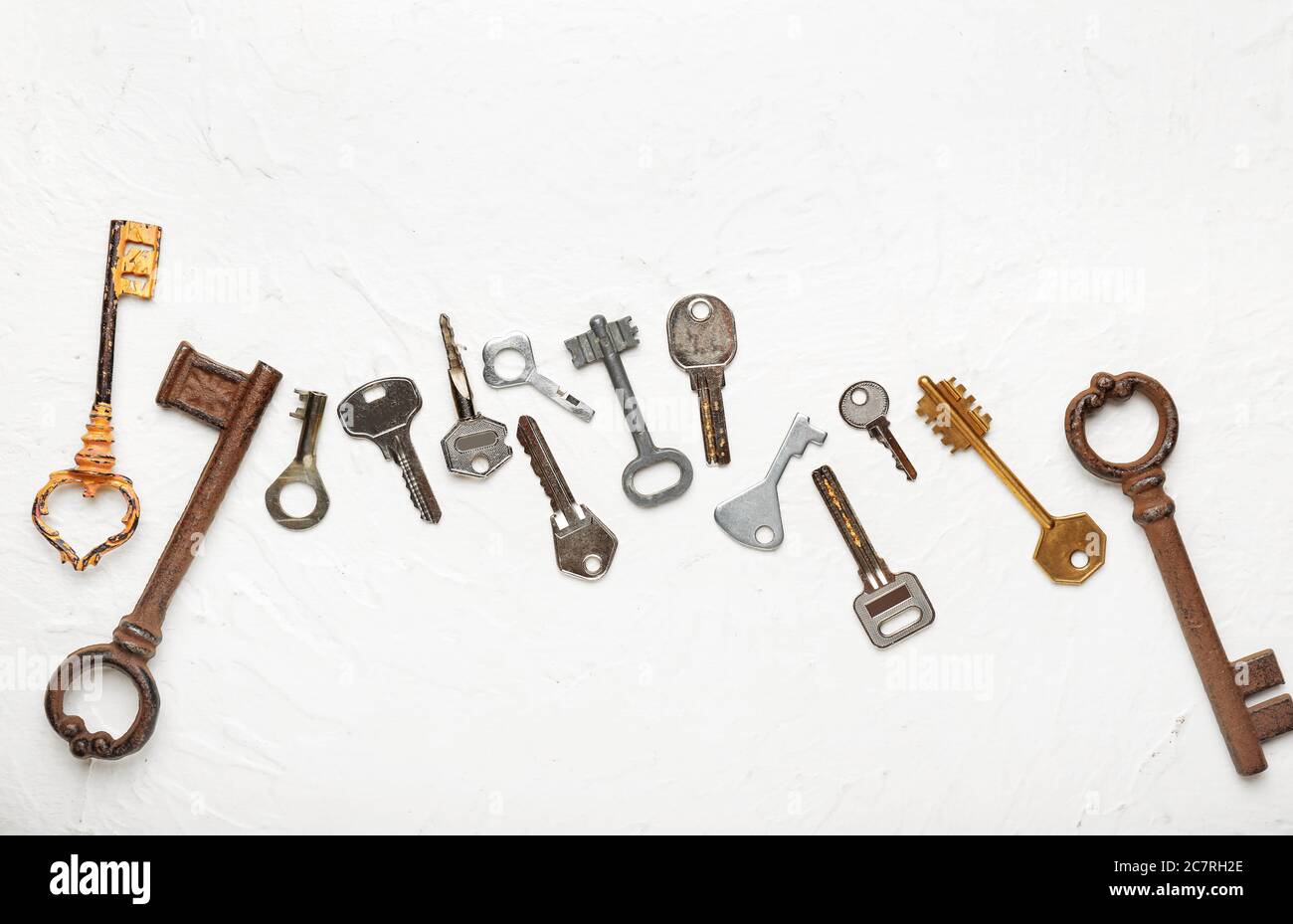 Many keys on white background Stock Photo - Alamy