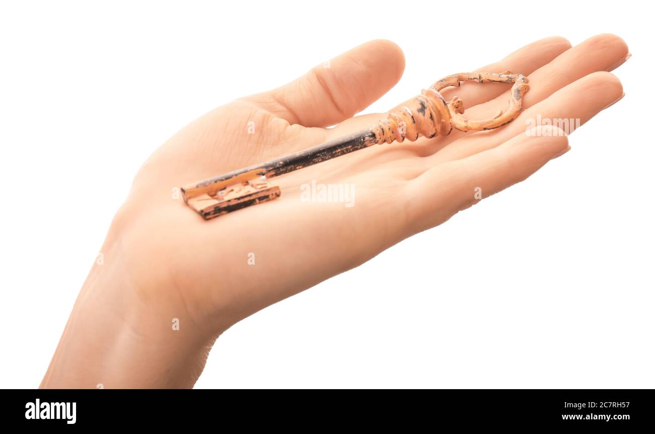 Female hand with key on white background Stock Photo - Alamy