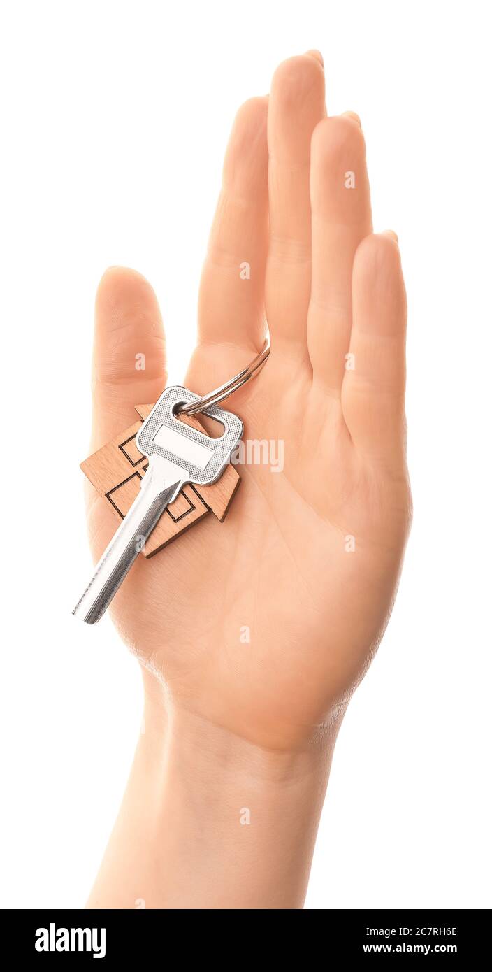 Female hand with key from house on white background Stock Photo - Alamy