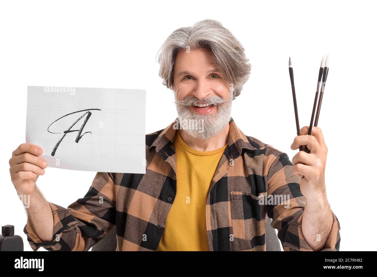 Senior male calligraphist on white background Stock Photo - Alamy