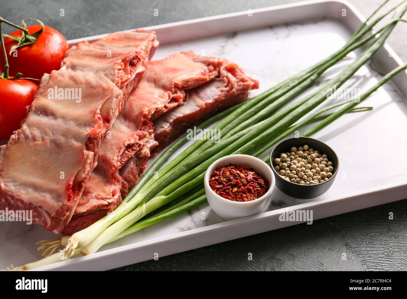 Raw beef short ribs with vegetables and spices on table Stock Photo - Alamy
