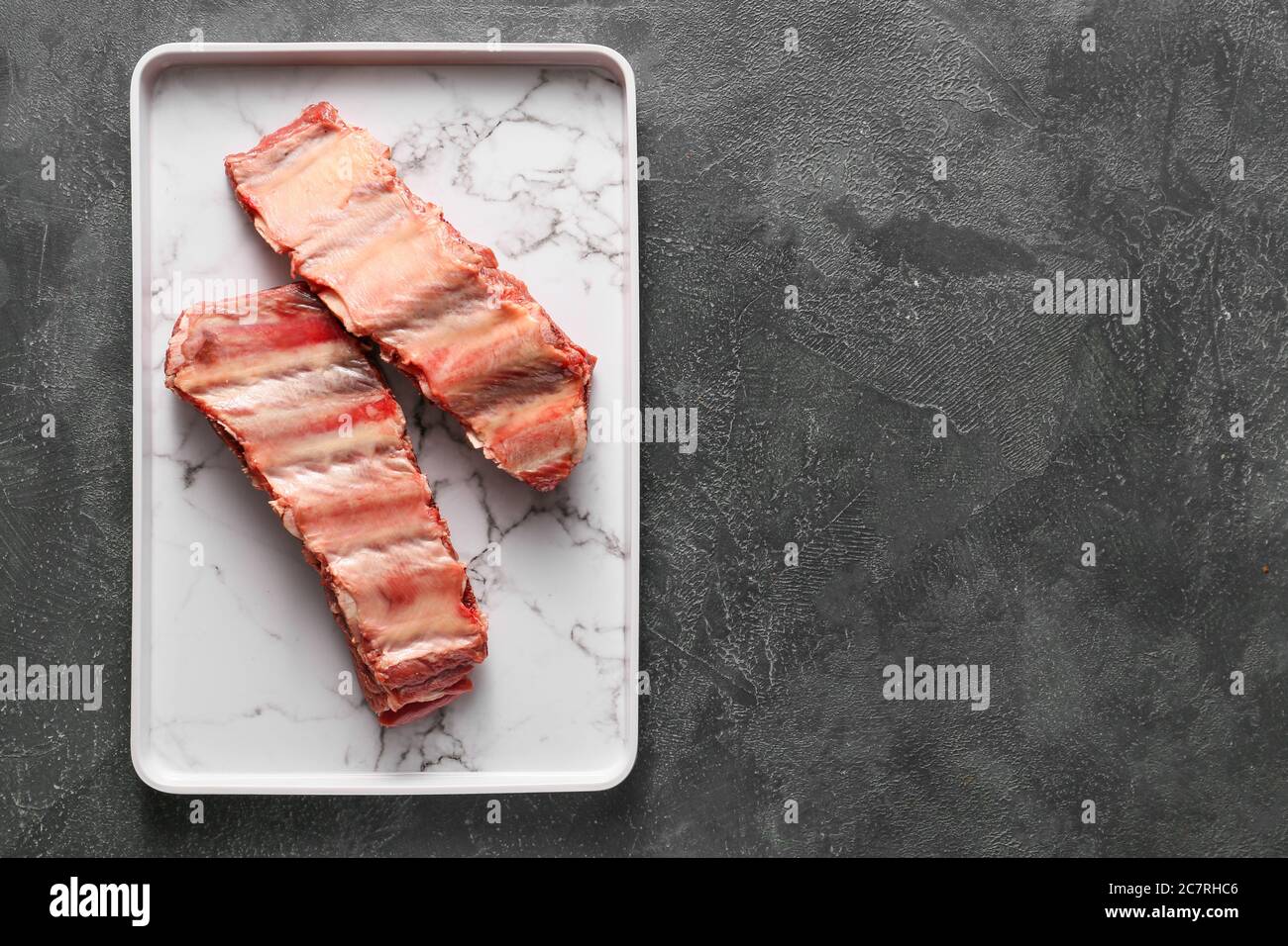 Raw beef short ribs on dark background Stock Photo - Alamy
