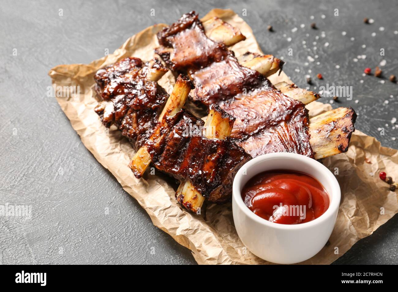 Tasty beef short ribs with sauce on dark background Stock Photo - Alamy