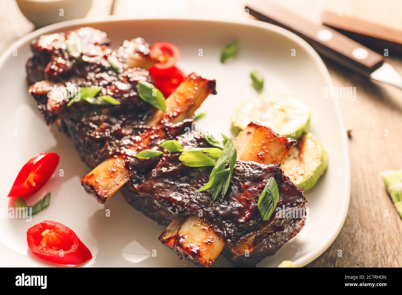 Tasty beef short ribs with vegetables on plate, closeup Stock Photo - Alamy