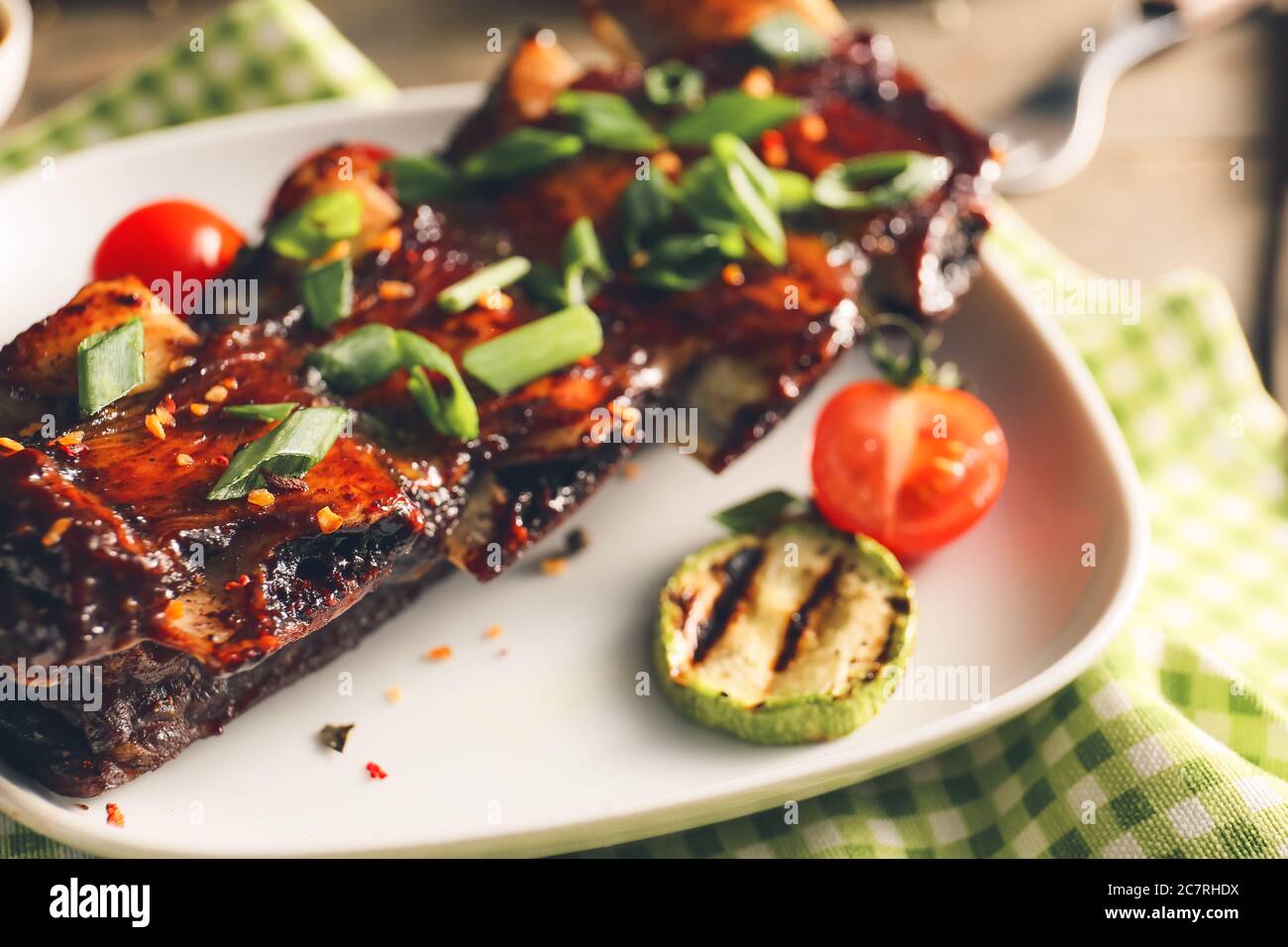 Tasty beef short ribs with vegetables on plate, closeup Stock Photo - Alamy