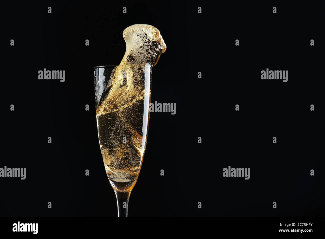 Glass of champagne with splash on dark background Stock Photo - Alamy