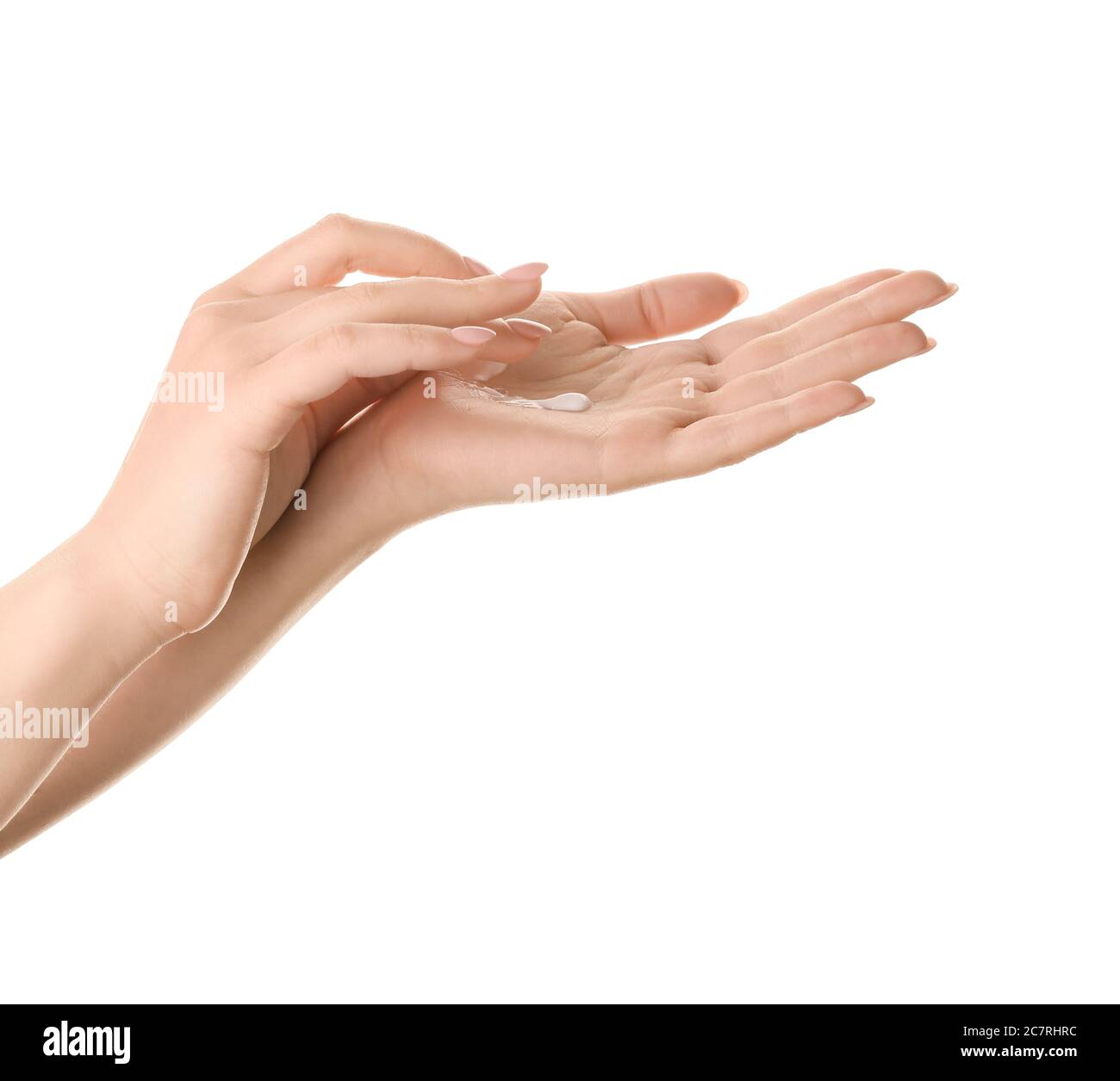 Beautiful young woman applying hand cream against white background ...