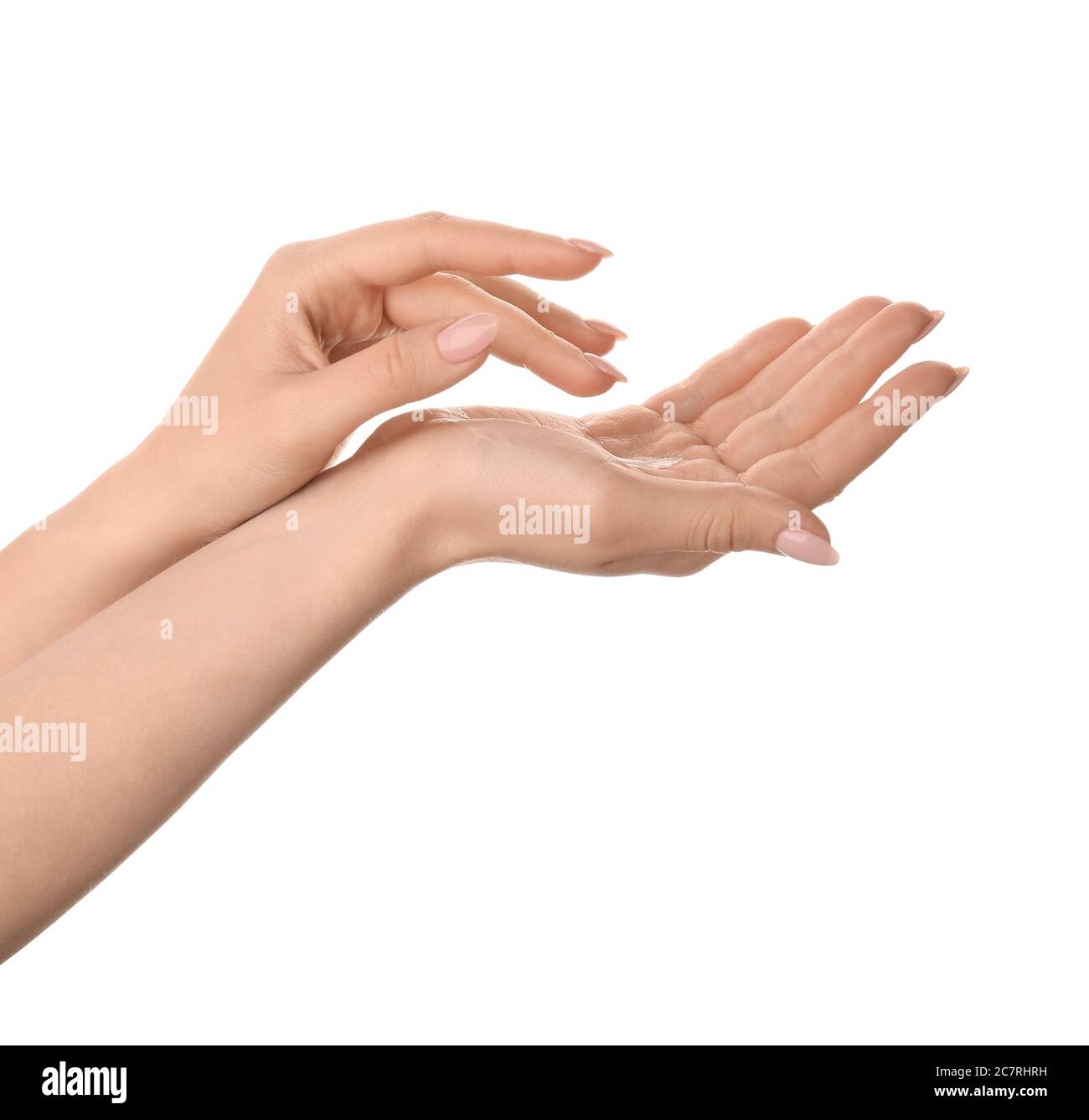 Beautiful young woman applying hand cream against white background ...