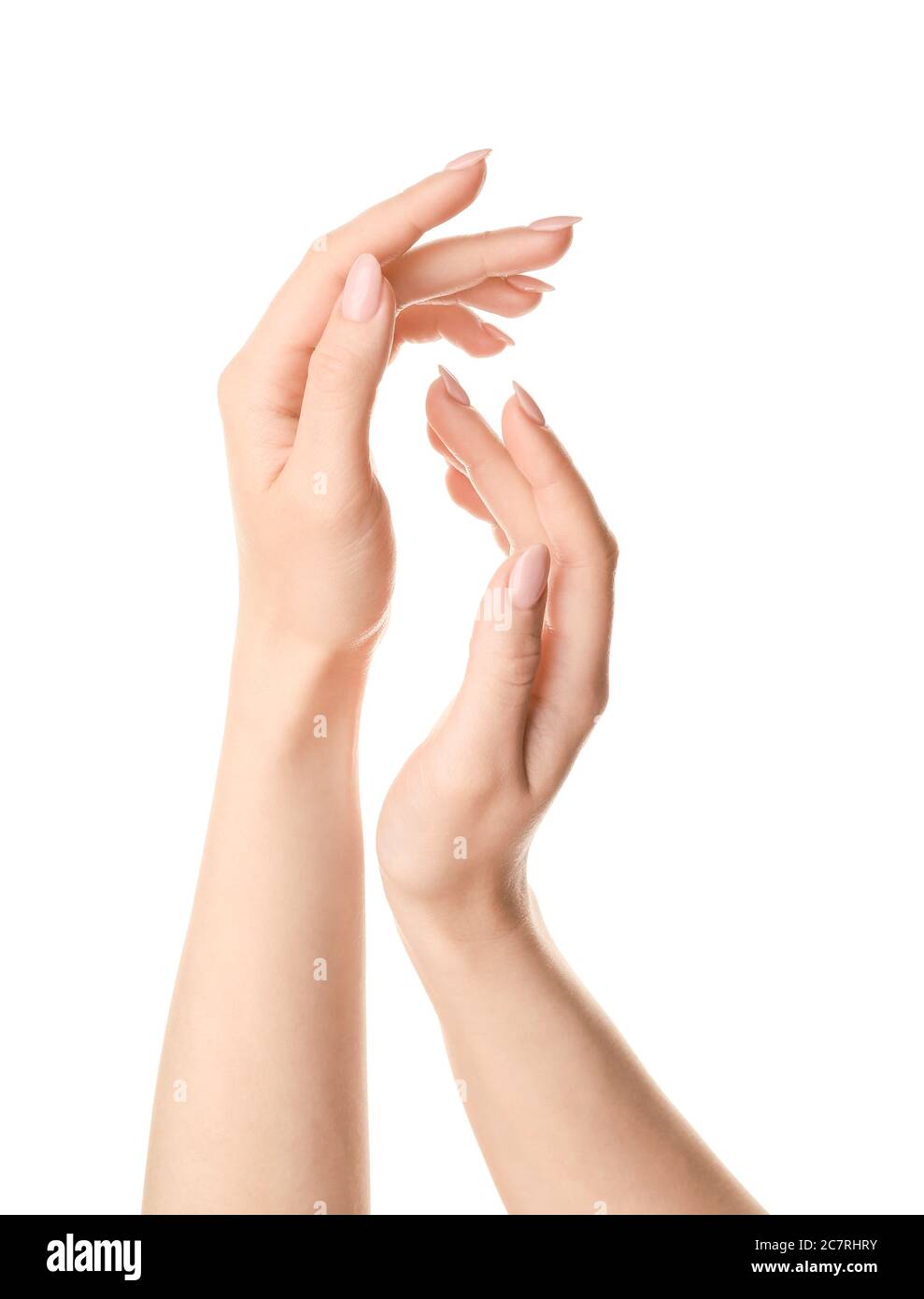 Beautiful young woman applying hand cream against white background ...