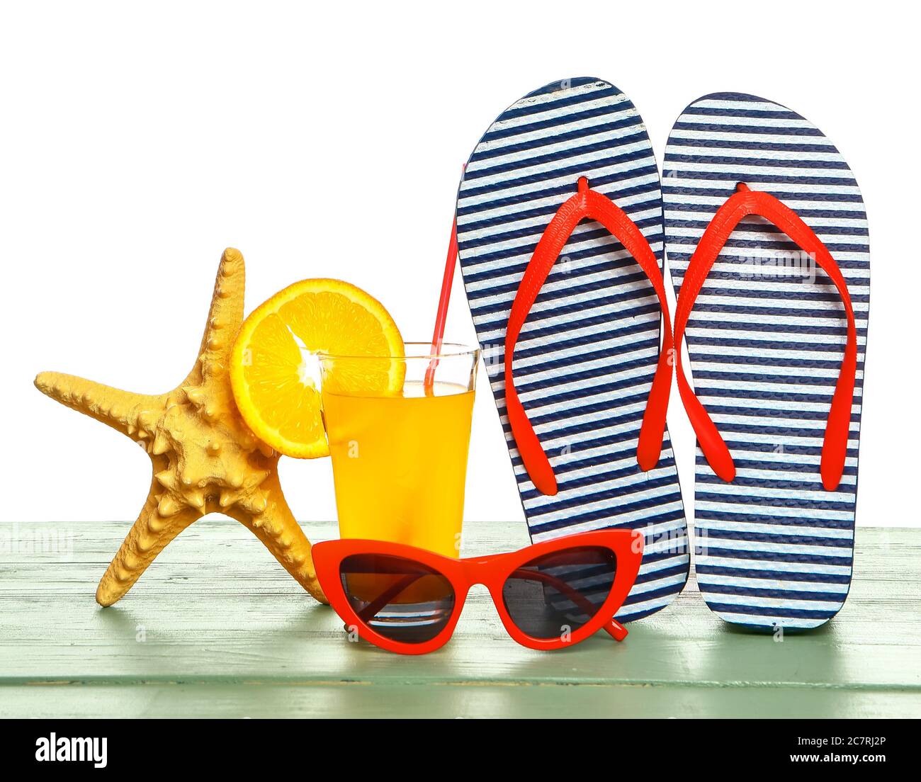 Set of beach accessories on table against white background Stock Photo ...