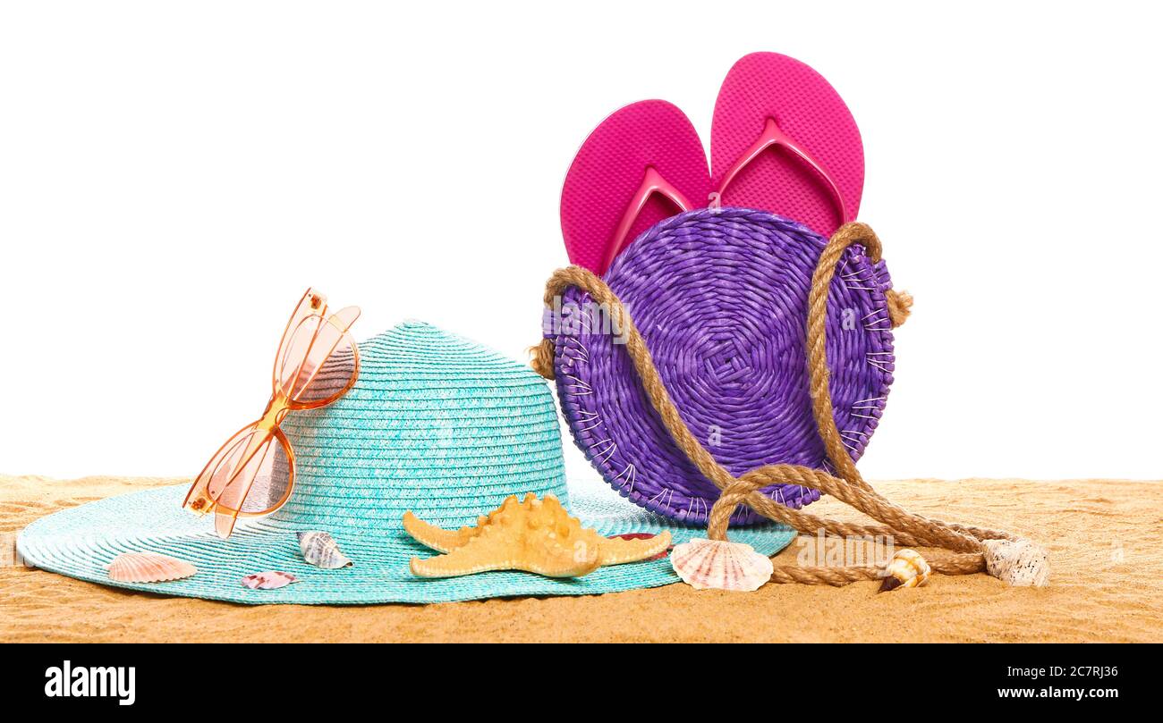 Set of beach accessories on sand against white background Stock Photo ...