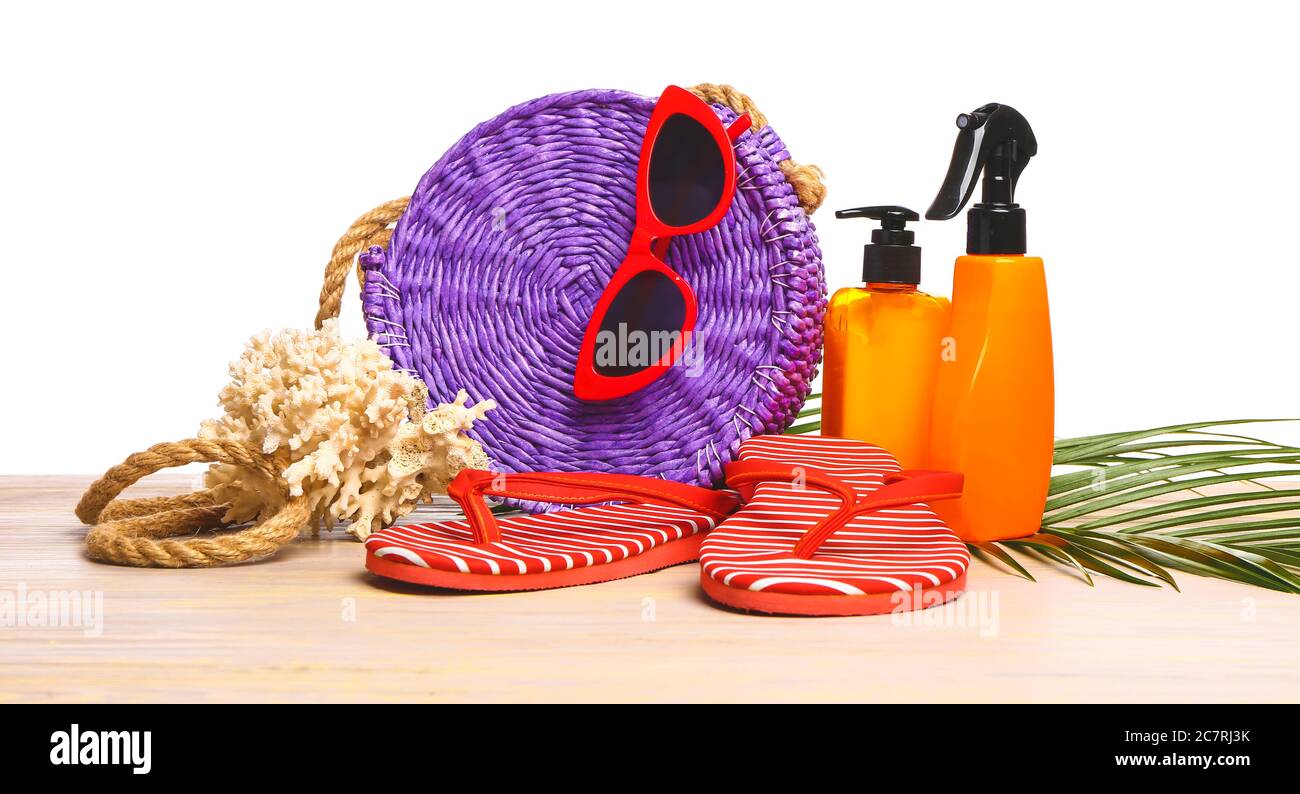 Set of beach accessories on table against white background Stock Photo ...