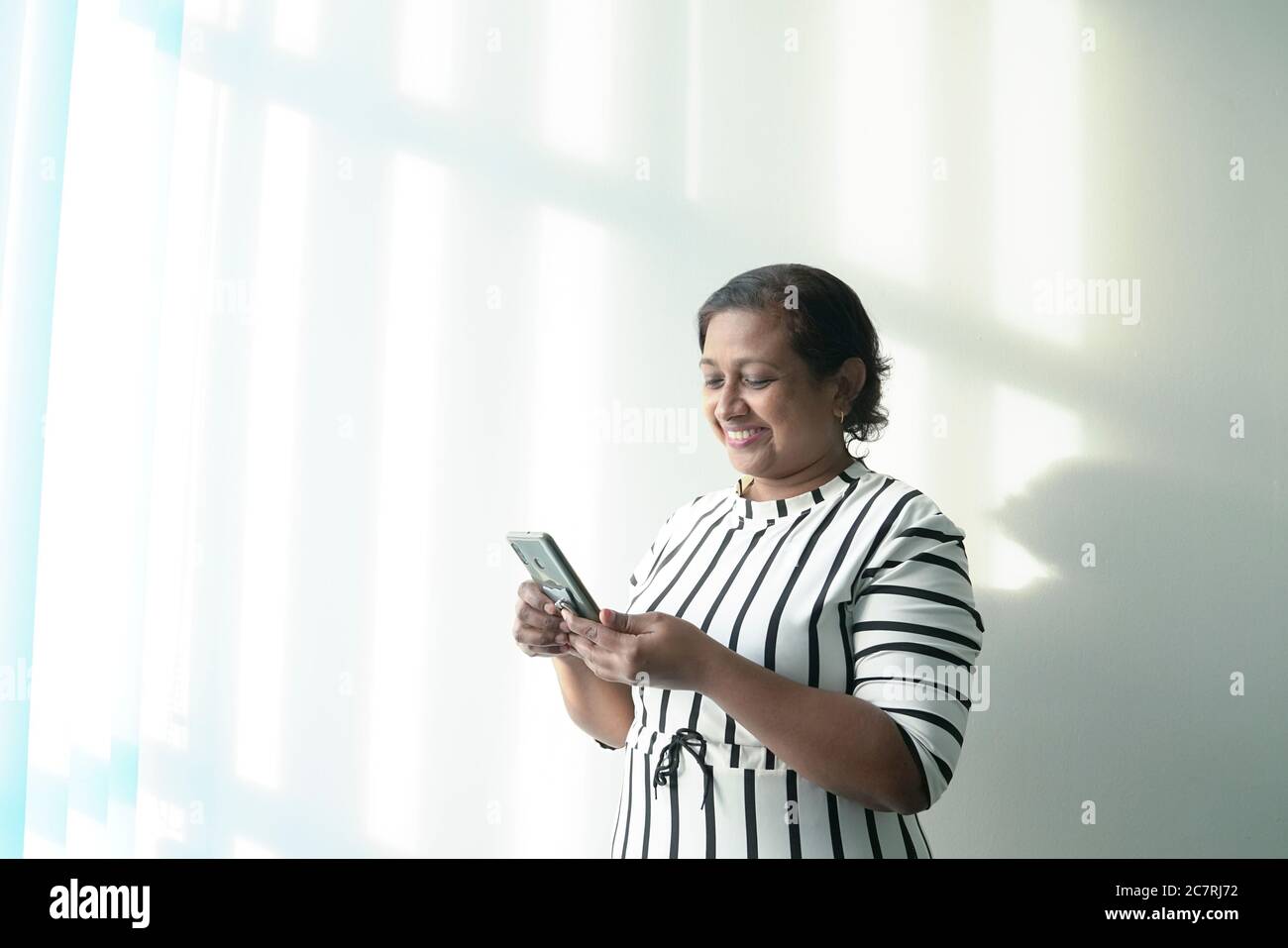 Smiling while texting hi-res stock photography and images - Alamy