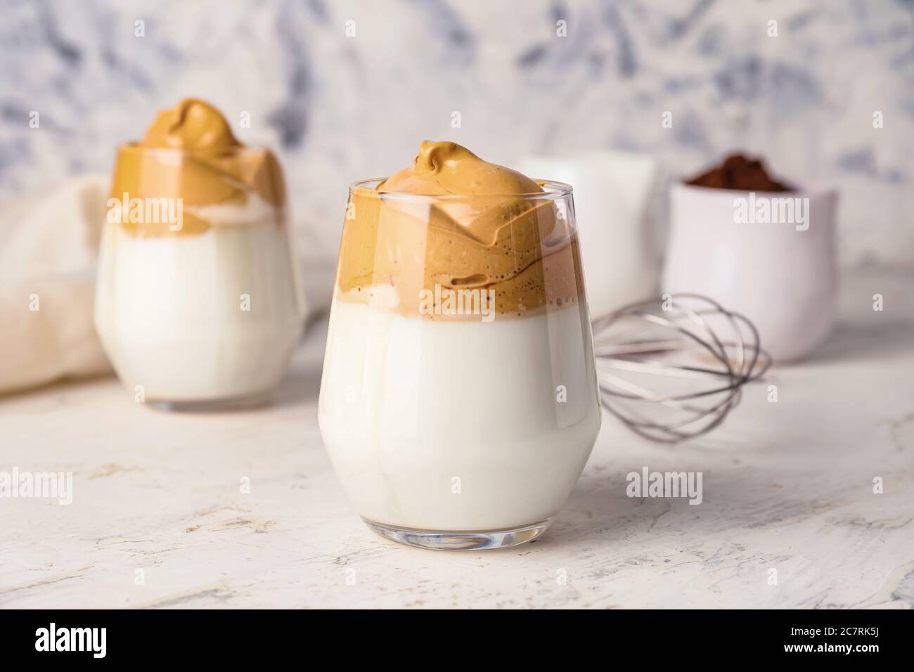 Glass of tasty dalgona coffee on white background Stock Photo - Alamy