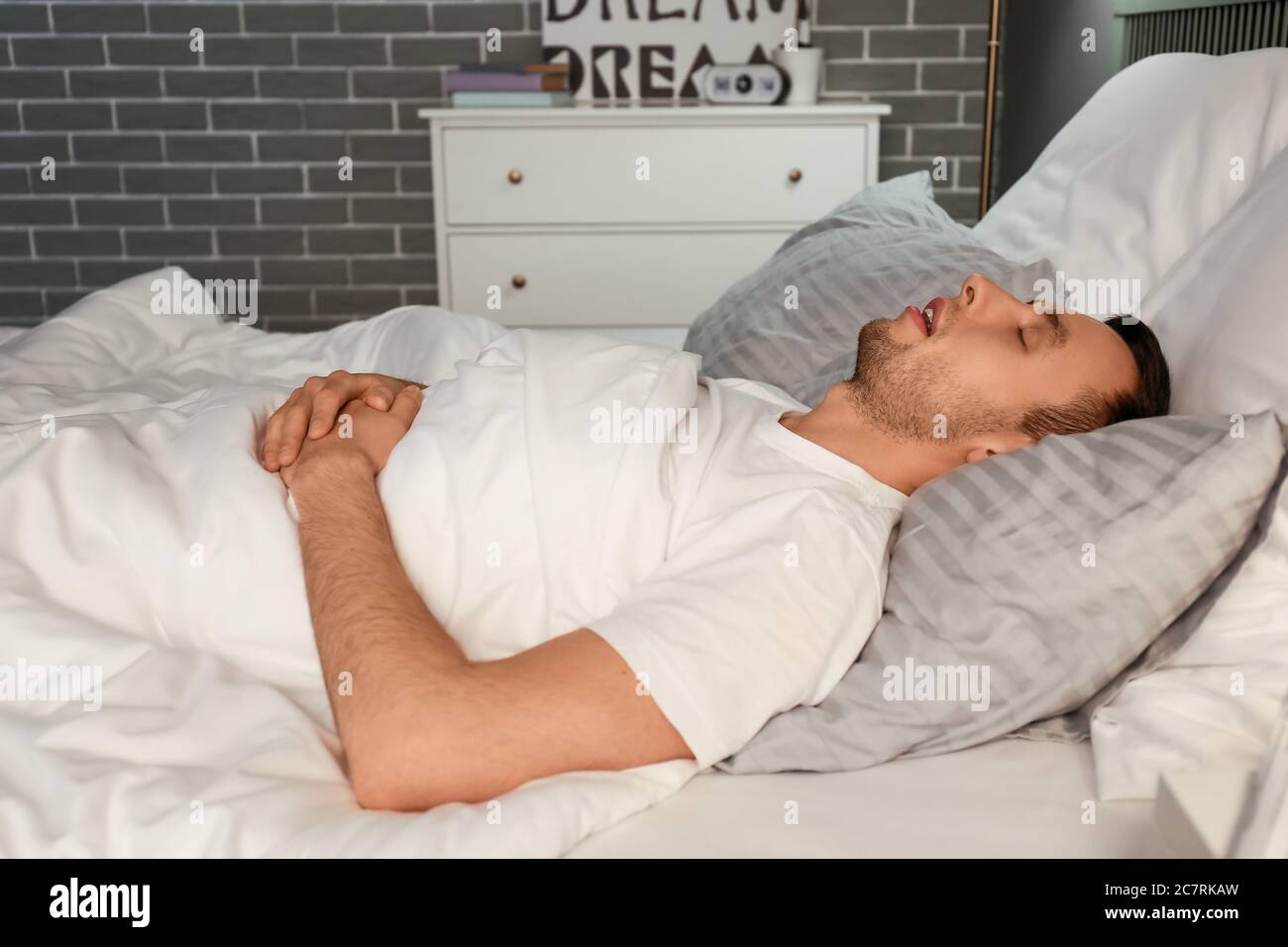 Young man snoring while sleeping in bed. Apnea problem Stock Photo - Alamy Young man snoring while sleeping in bed. Apnea problem Stock Photo - Alamy