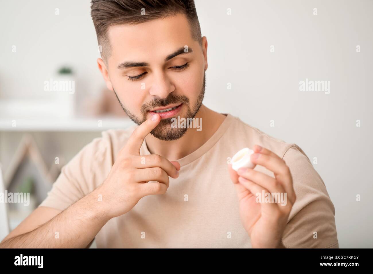 Man applying lip balm hi-res stock photography and images - Alamy