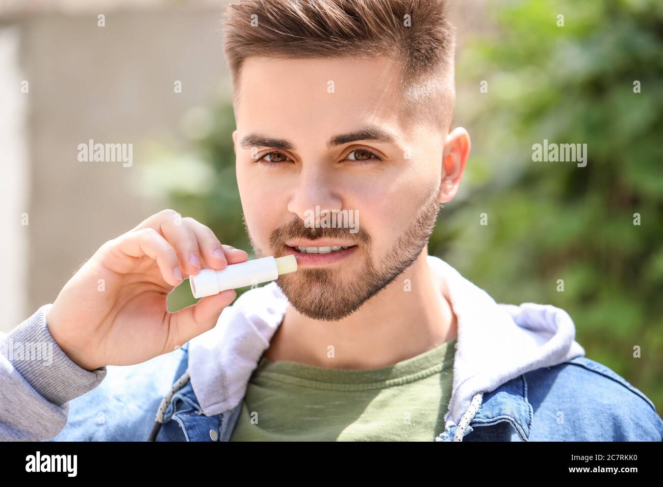Man applying lip balm hi-res stock photography and images - Alamy