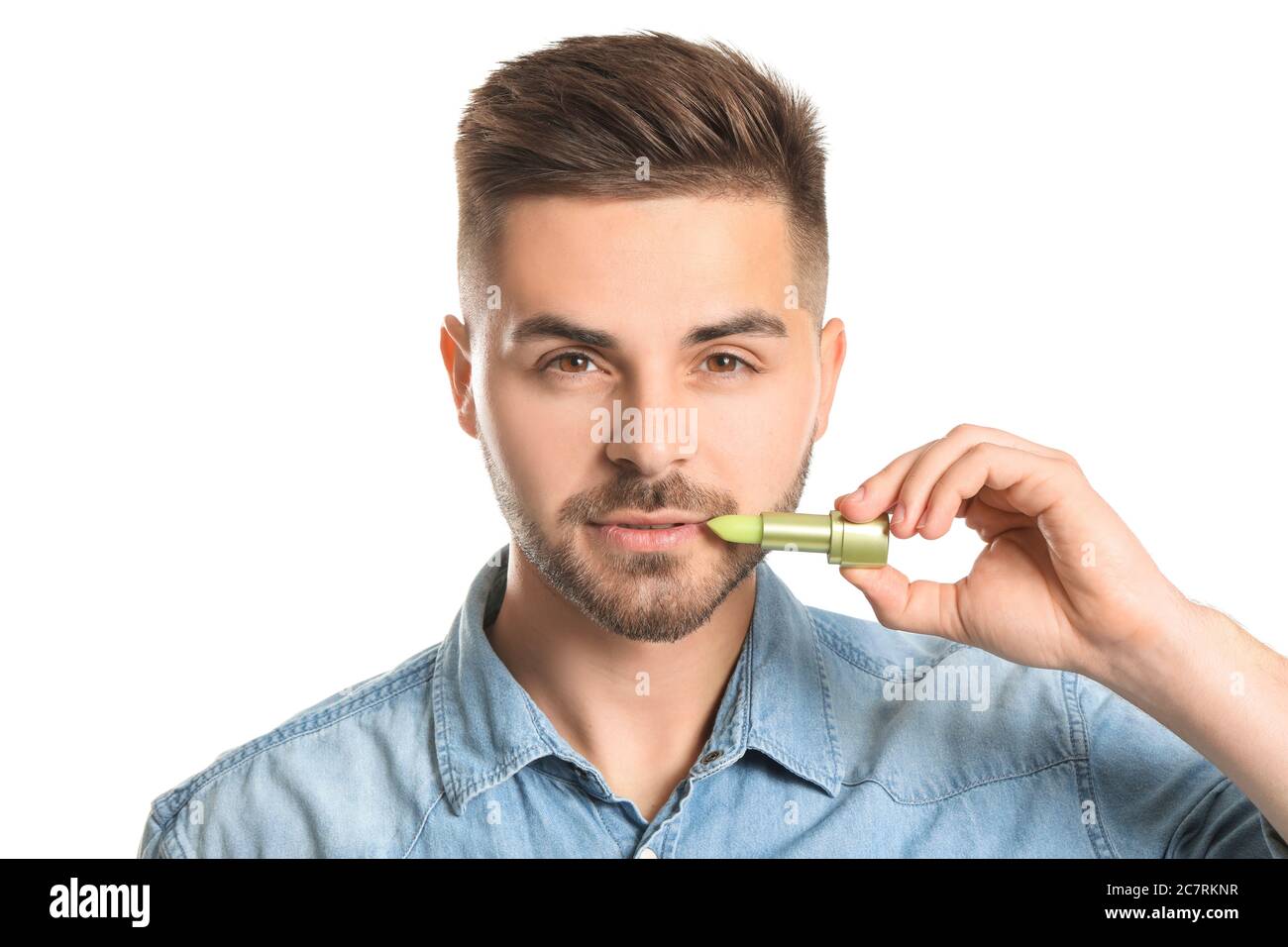 Handsome young man with lip balm on white background Stock Photo - Alamy