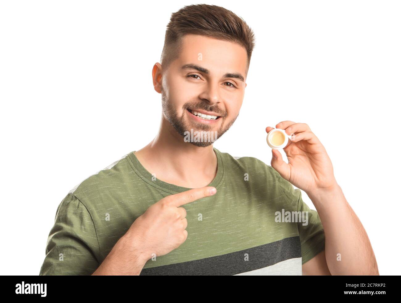 Handsome young man with lip balm on white background Stock Photo - Alamy