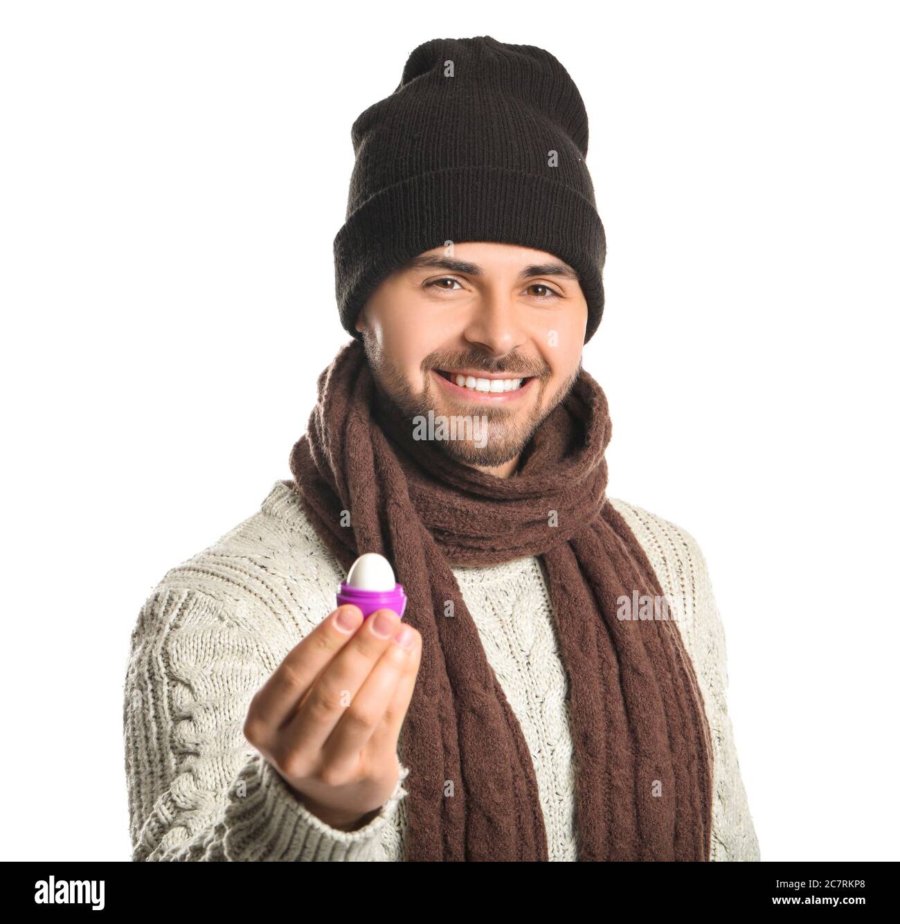 Handsome young man with lip balm on white background Stock Photo - Alamy