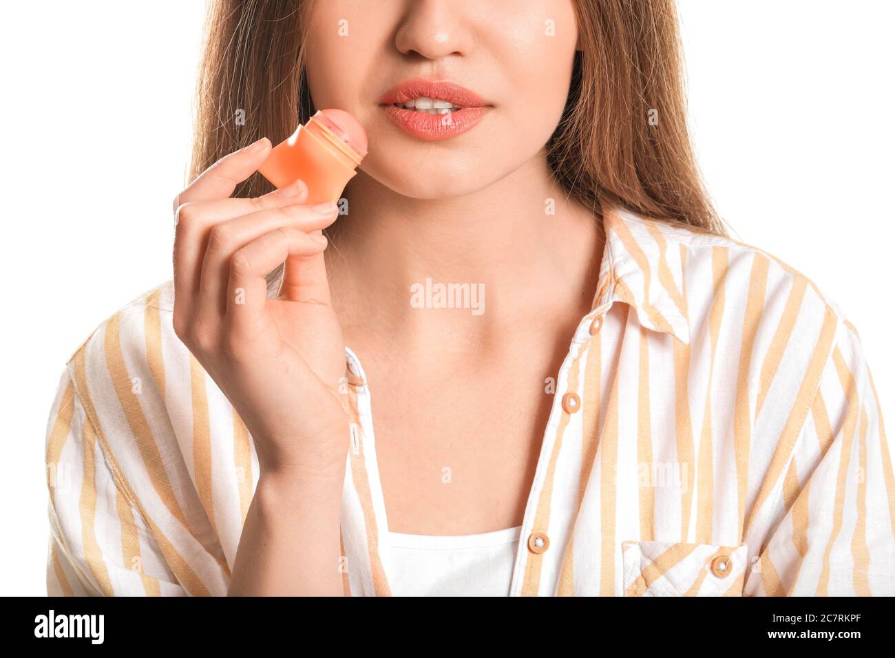 Beautiful young woman with lip balm on white background, closeup Stock ...
