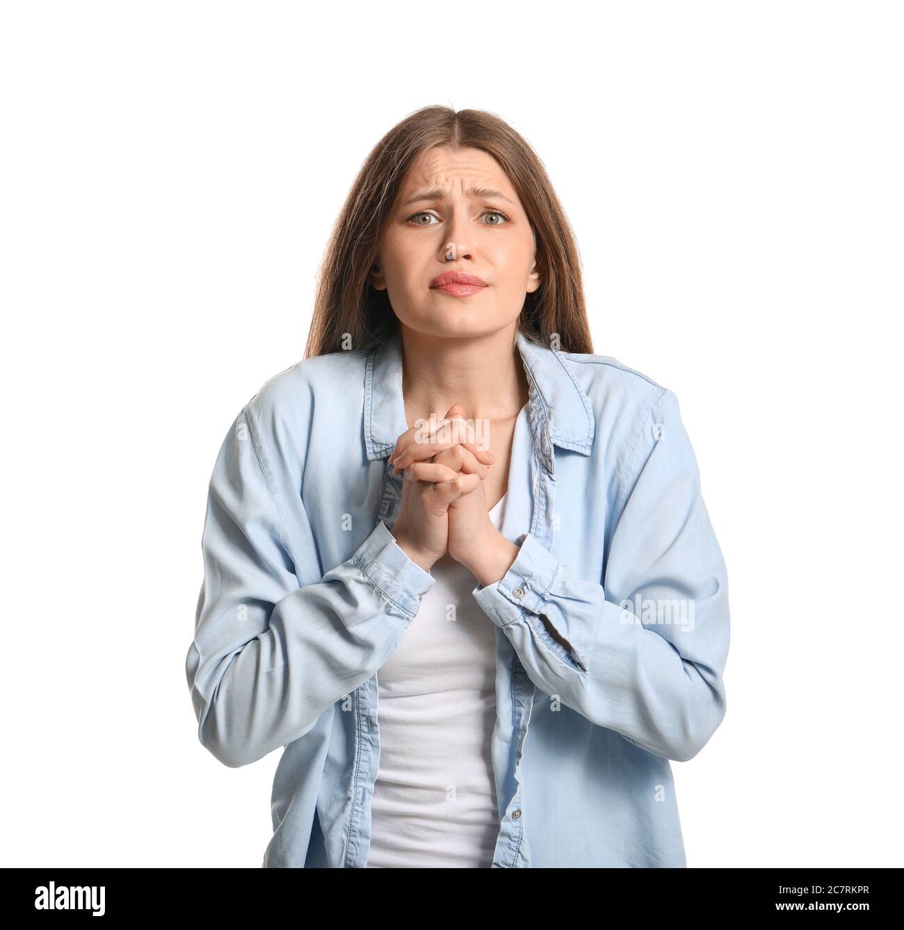 Apologizing young woman on white background Stock Photo - Alamy