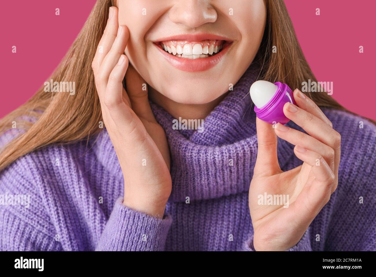 Beautiful young woman with lip balm on color background, closeup Stock ...