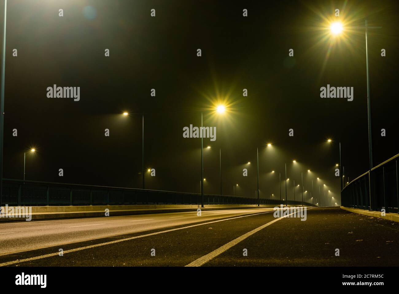 Misty empty bridge at night, Foggy empty Bridge at night, wet road at ...