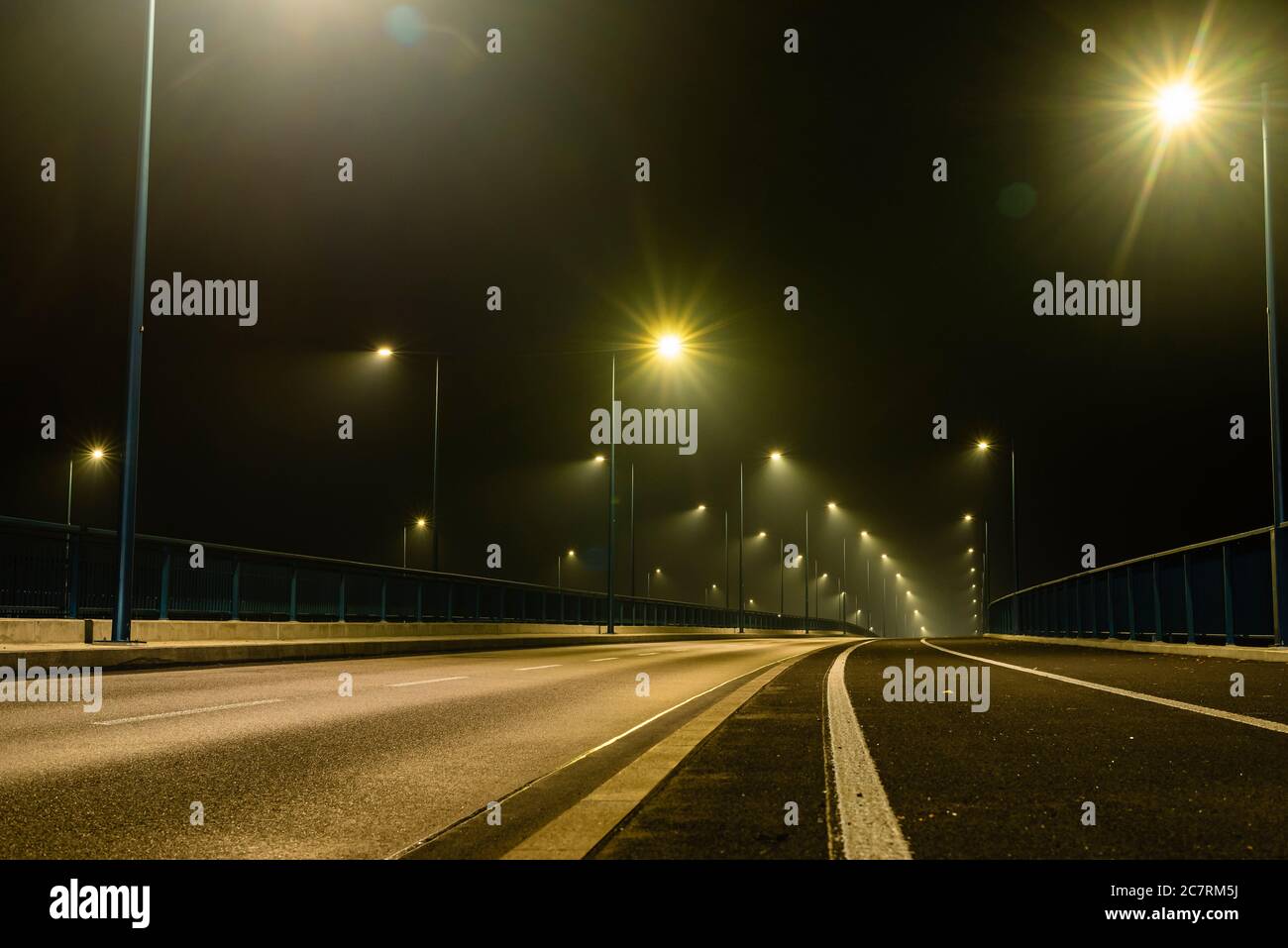 Misty empty bridge at night, Foggy empty Bridge at night, wet road at ...