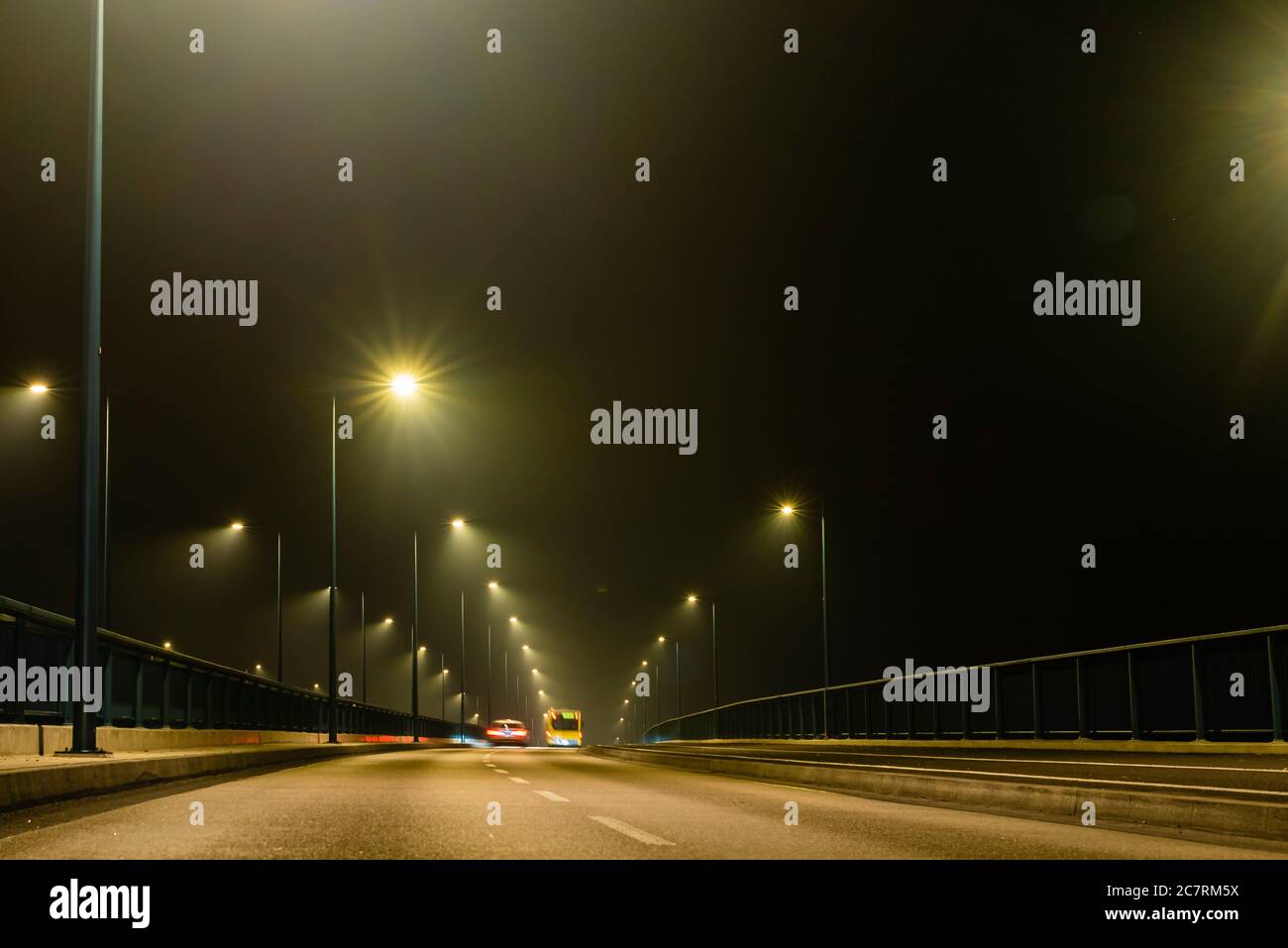 Misty empty bridge at night, Foggy empty Bridge at night, wet road at ...