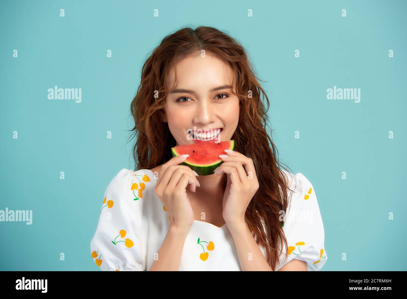 Portrait happy young Asian woman is holding slice of watermelon and ...
