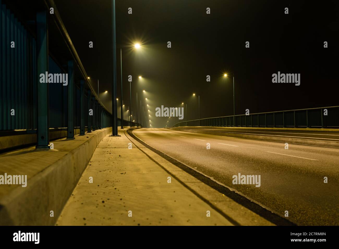 Misty empty bridge at night, Foggy empty Bridge at night, wet road at ...
