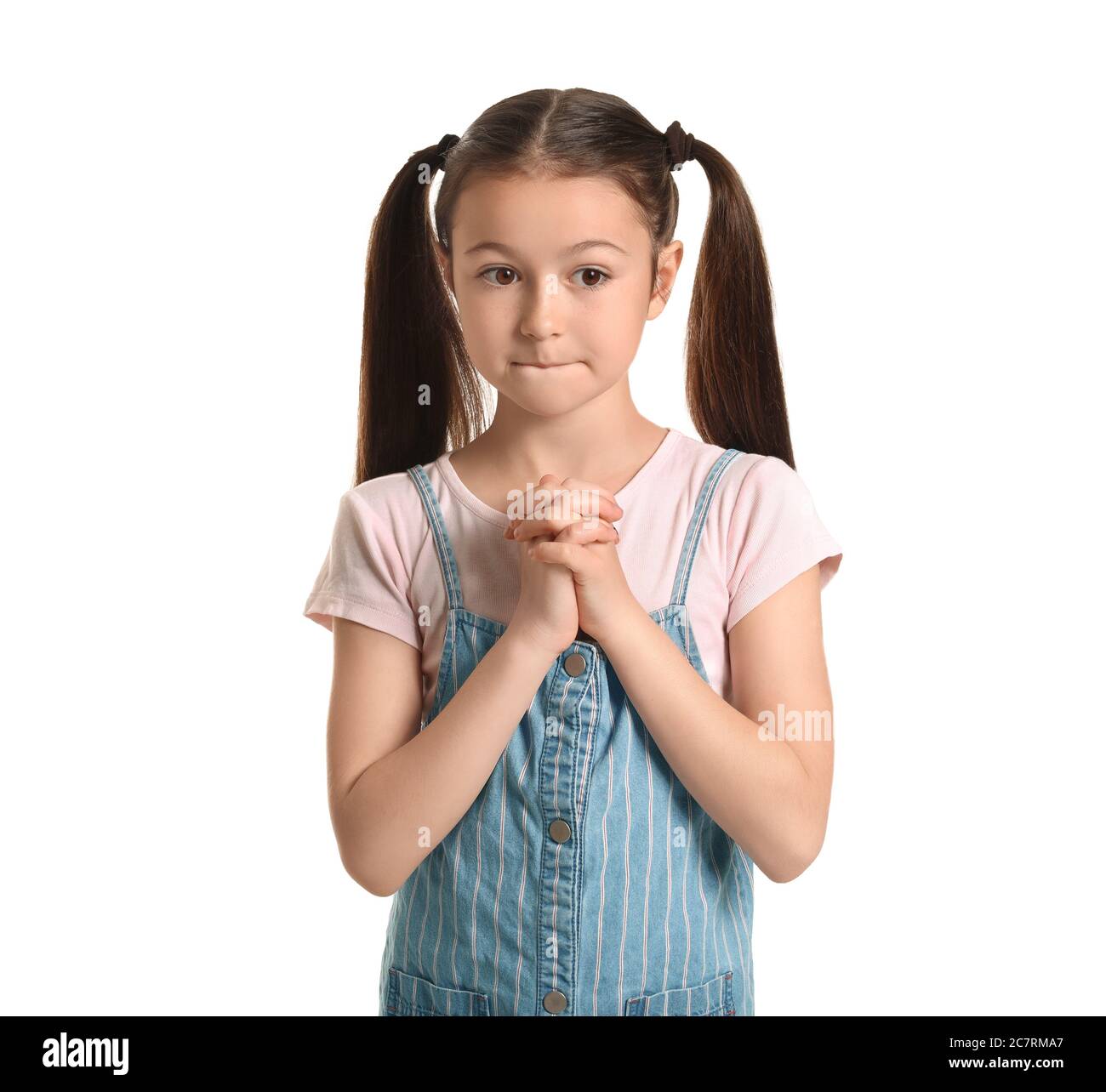 Apologizing little girl on white background Stock Photo - Alamy