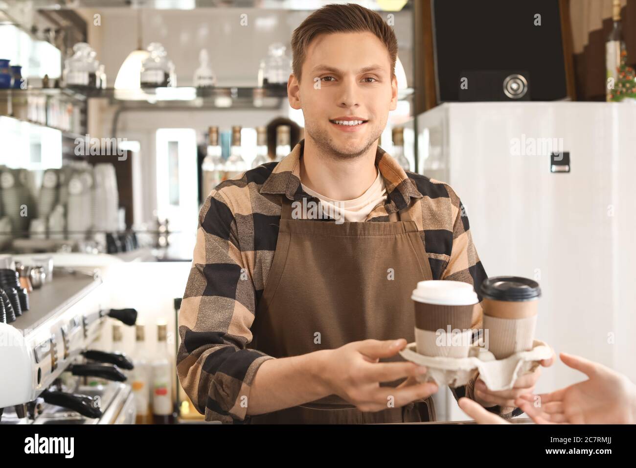 Barista giving coffee to client in cafe Stock Photo - Alamy
