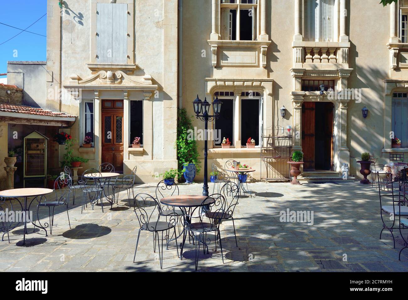 Empty coffee terrace with tables and chairs, Provence, France Stock ...