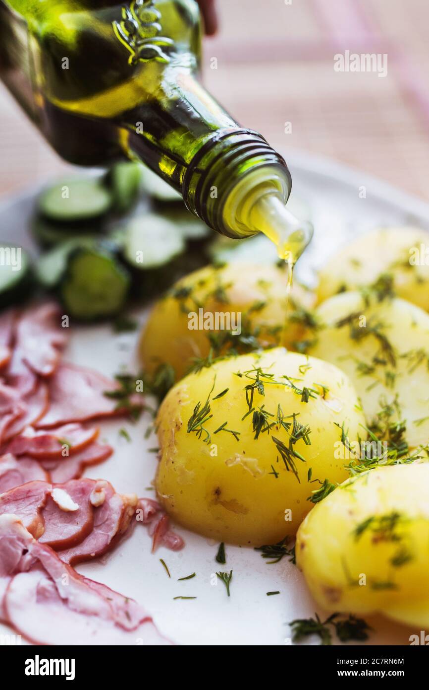 Boiled young potatoes with dill, lightly salted cucumbers and ham ...