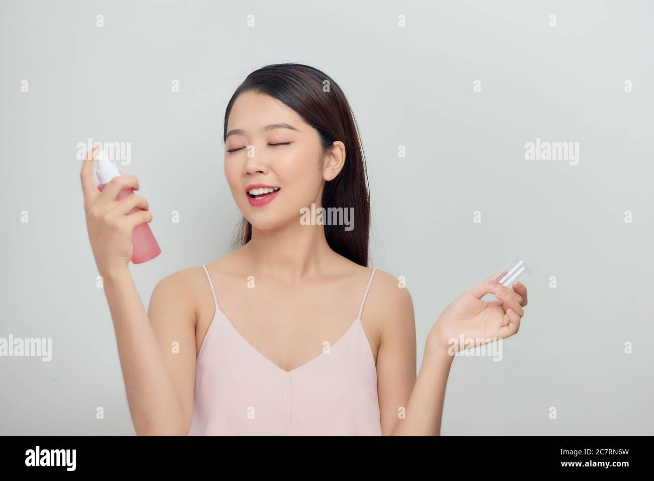 Beautiful woman face spray on face lotion cosmetology on white ...