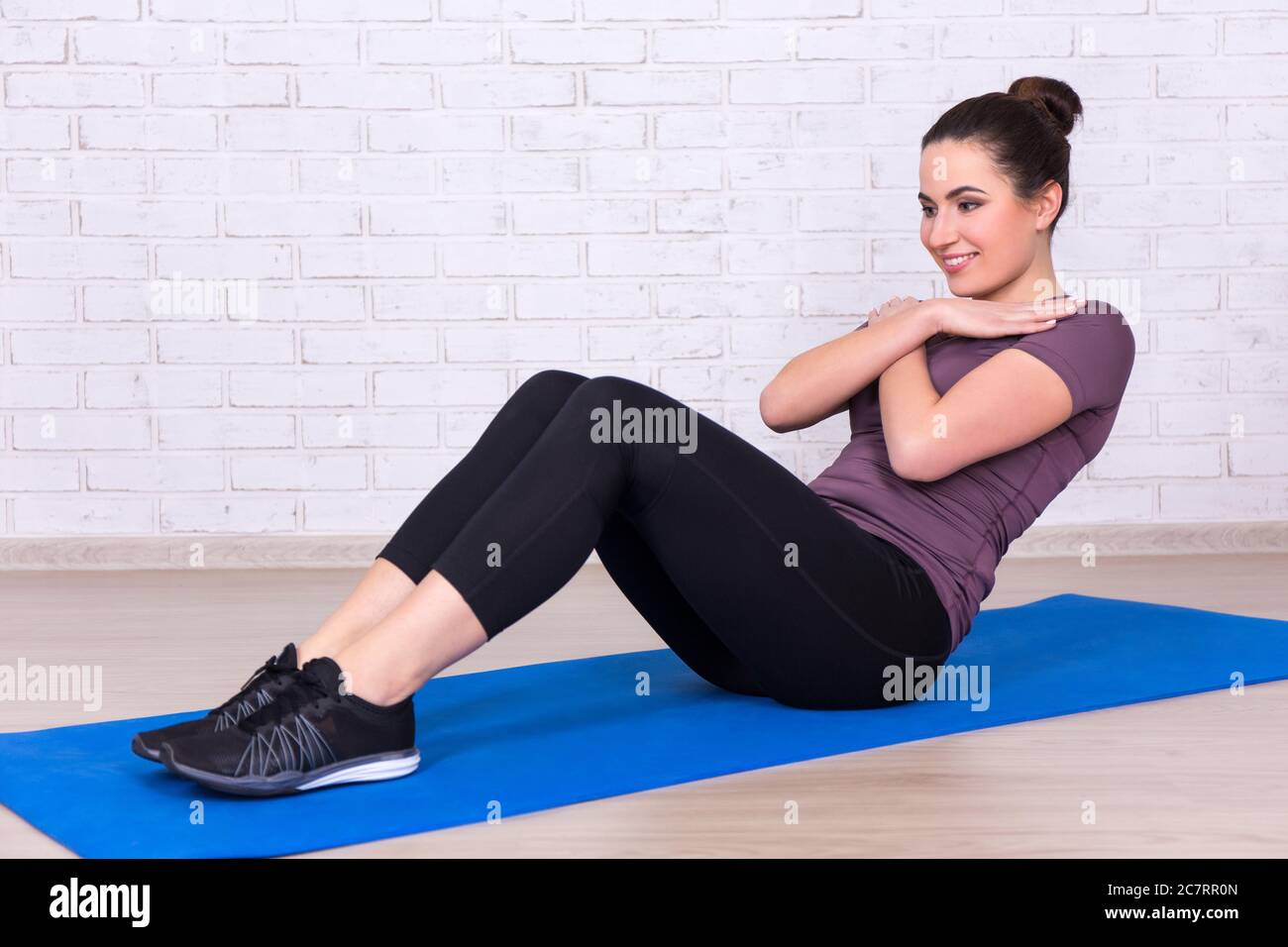 happy slim woman doing exercises for abdominal muscles Stock Photo - Alamy