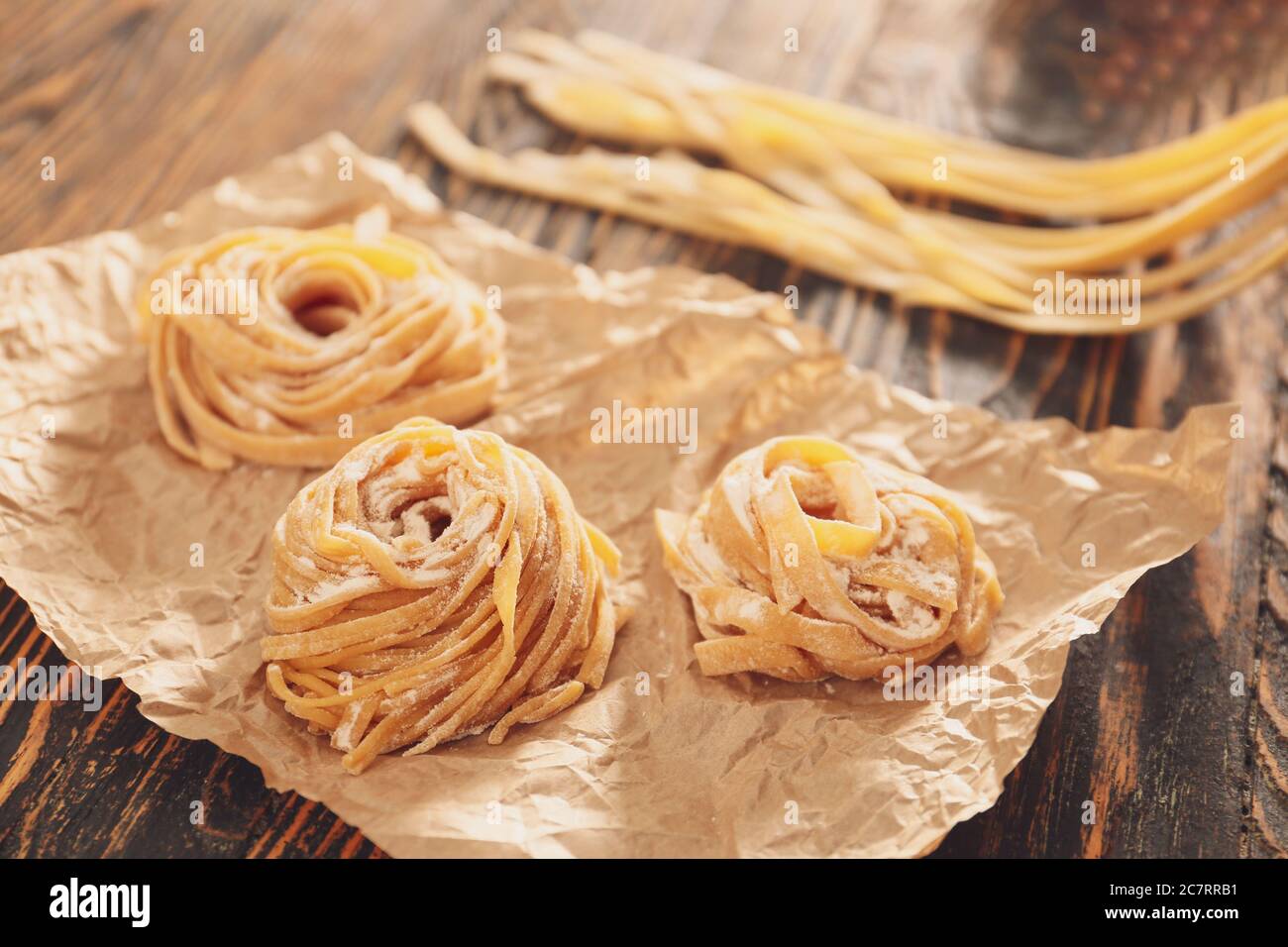 Raw pasta on kitchen table Stock Photo - Alamy