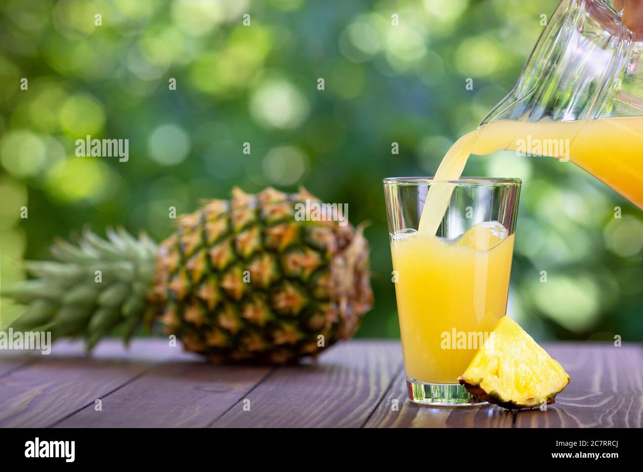 pineapple juice pouring into glass Stock Photo - Alamy