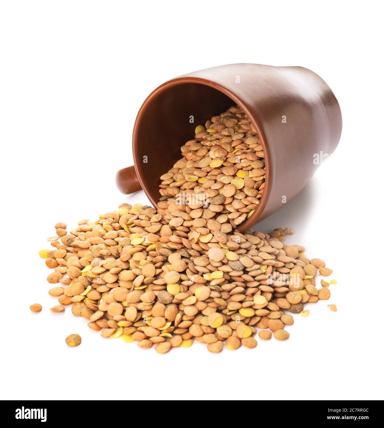 Overturned cup with raw lentils on white background Stock Photo - Alamy