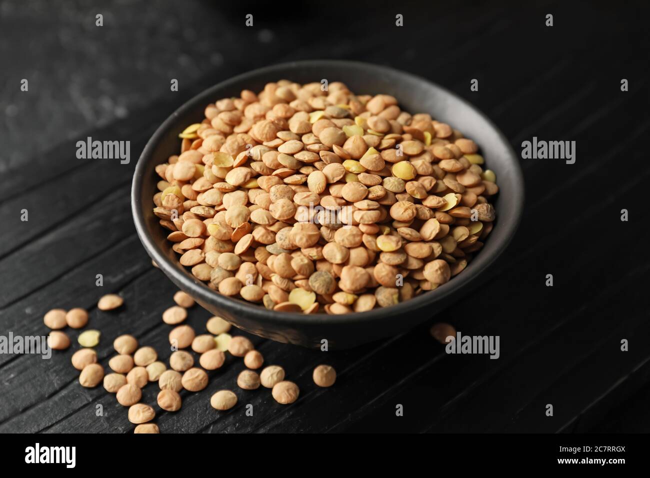 Raw lentils in bowl on table Stock Photo - Alamy