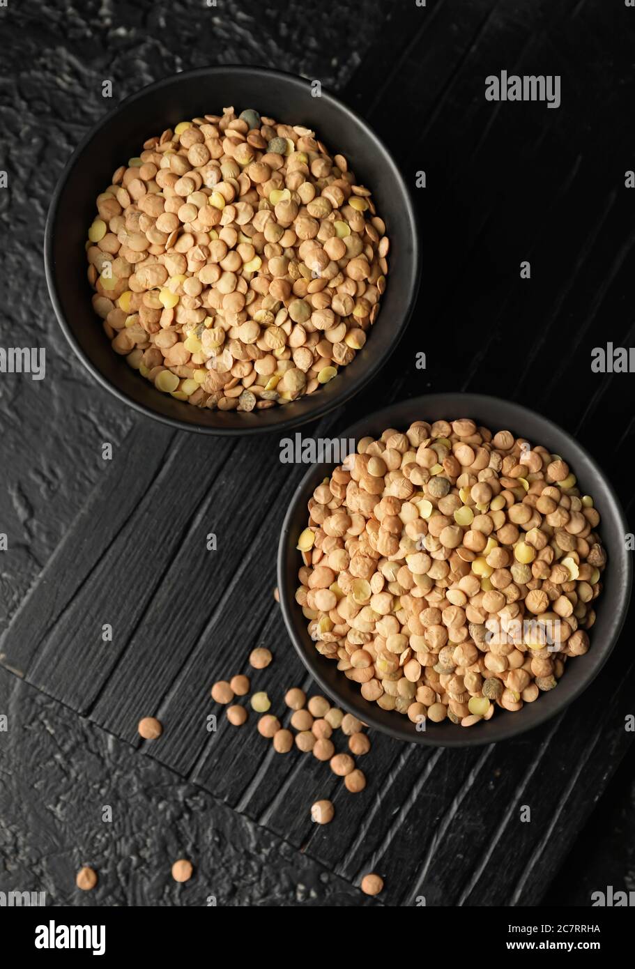 Raw lentils in bowls on table Stock Photo - Alamy