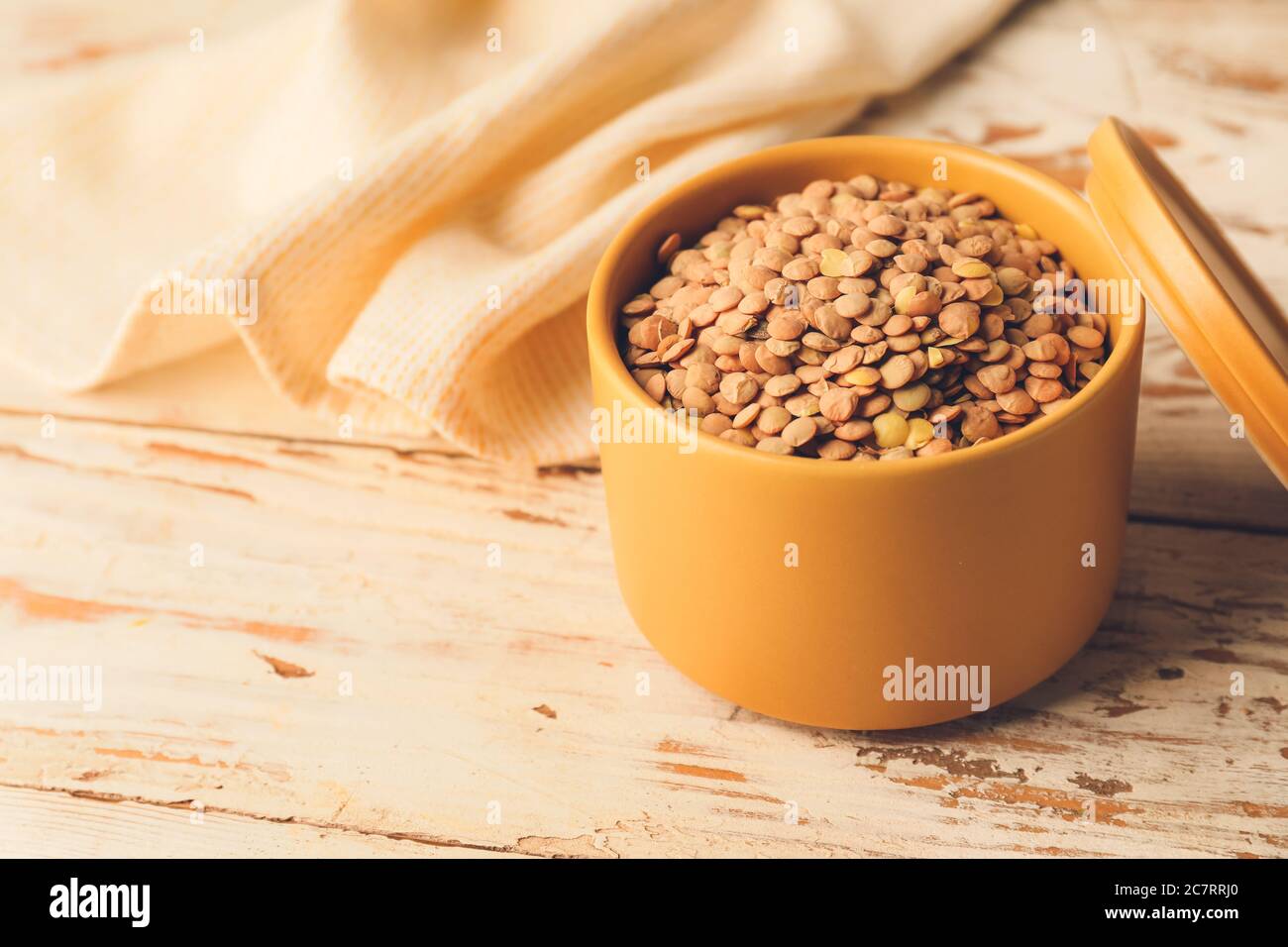 Raw lentils in box on table Stock Photo - Alamy