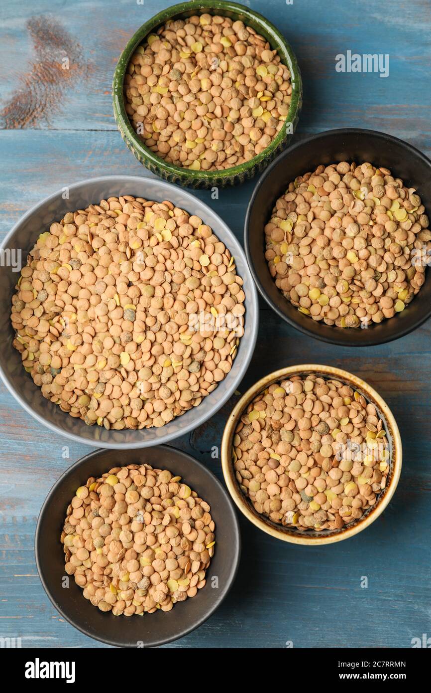 Raw lentils in bowls on table Stock Photo - Alamy