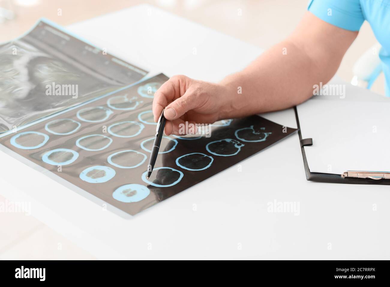 Senior neurologist with MRI scan of human head in clinic Stock Photo ...