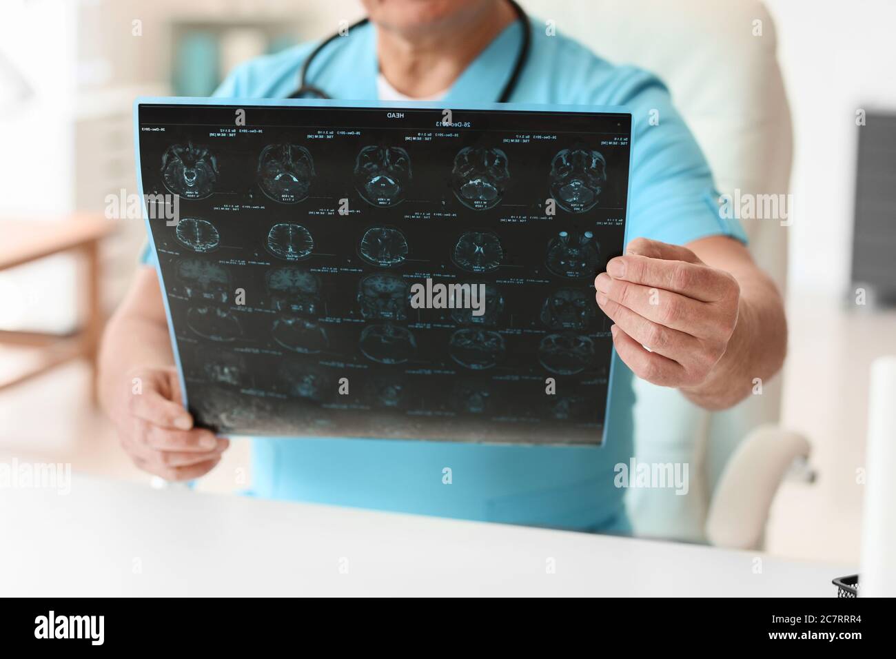 Senior neurologist with MRI scan of human head in clinic Stock Photo ...