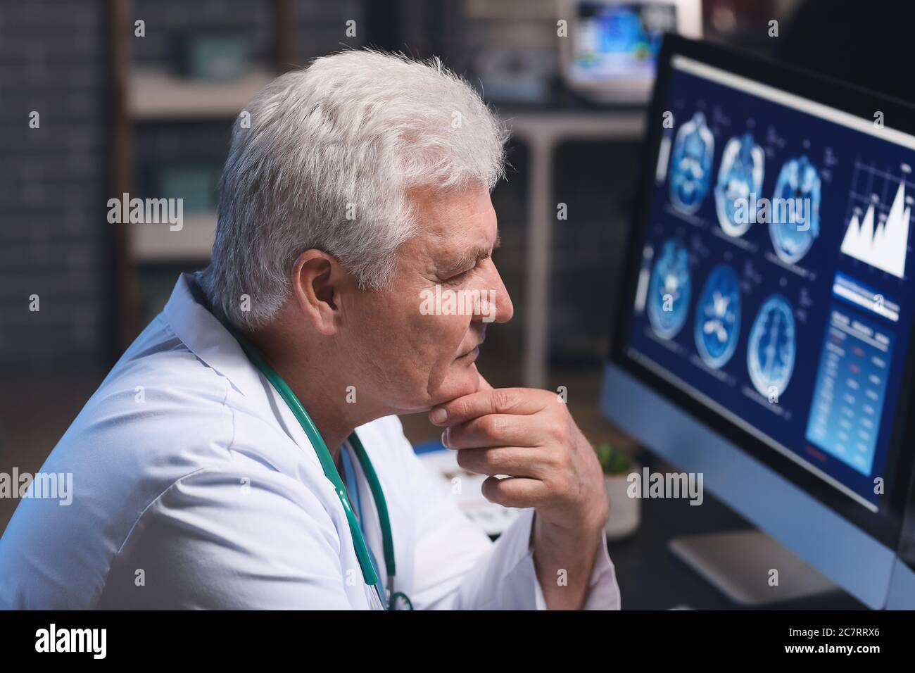 Senior neurologist with MRI scan of human head in clinic Stock Photo ...