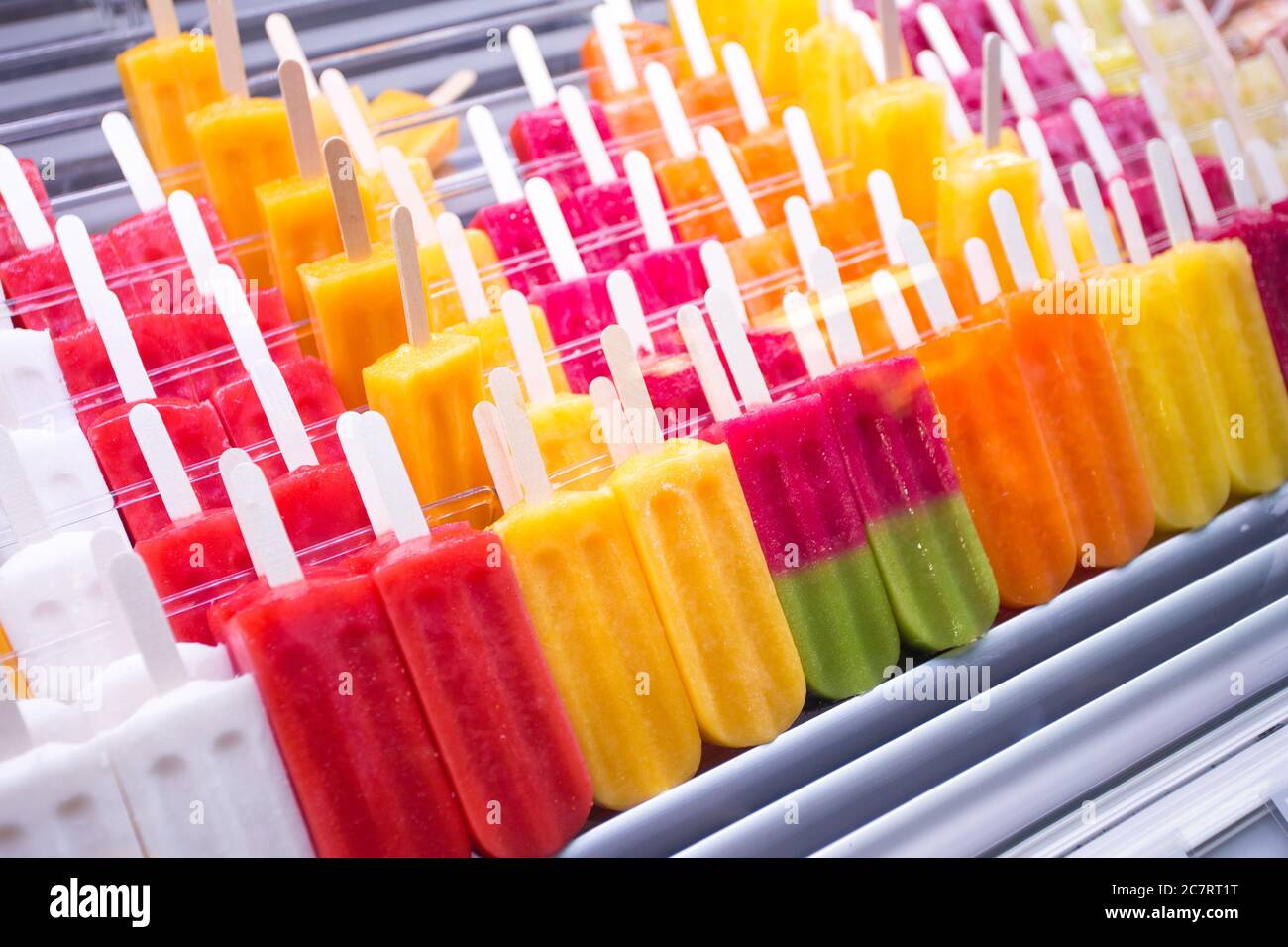 colorful assorted fruit popsicles on market stall Stock Photo - Alamy